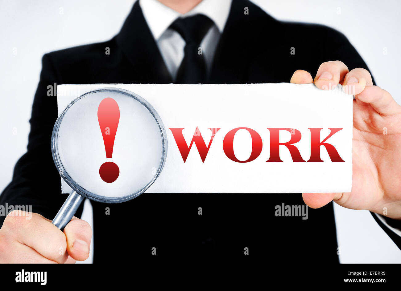 Business man magnifying work word Stock Photo - Alamy