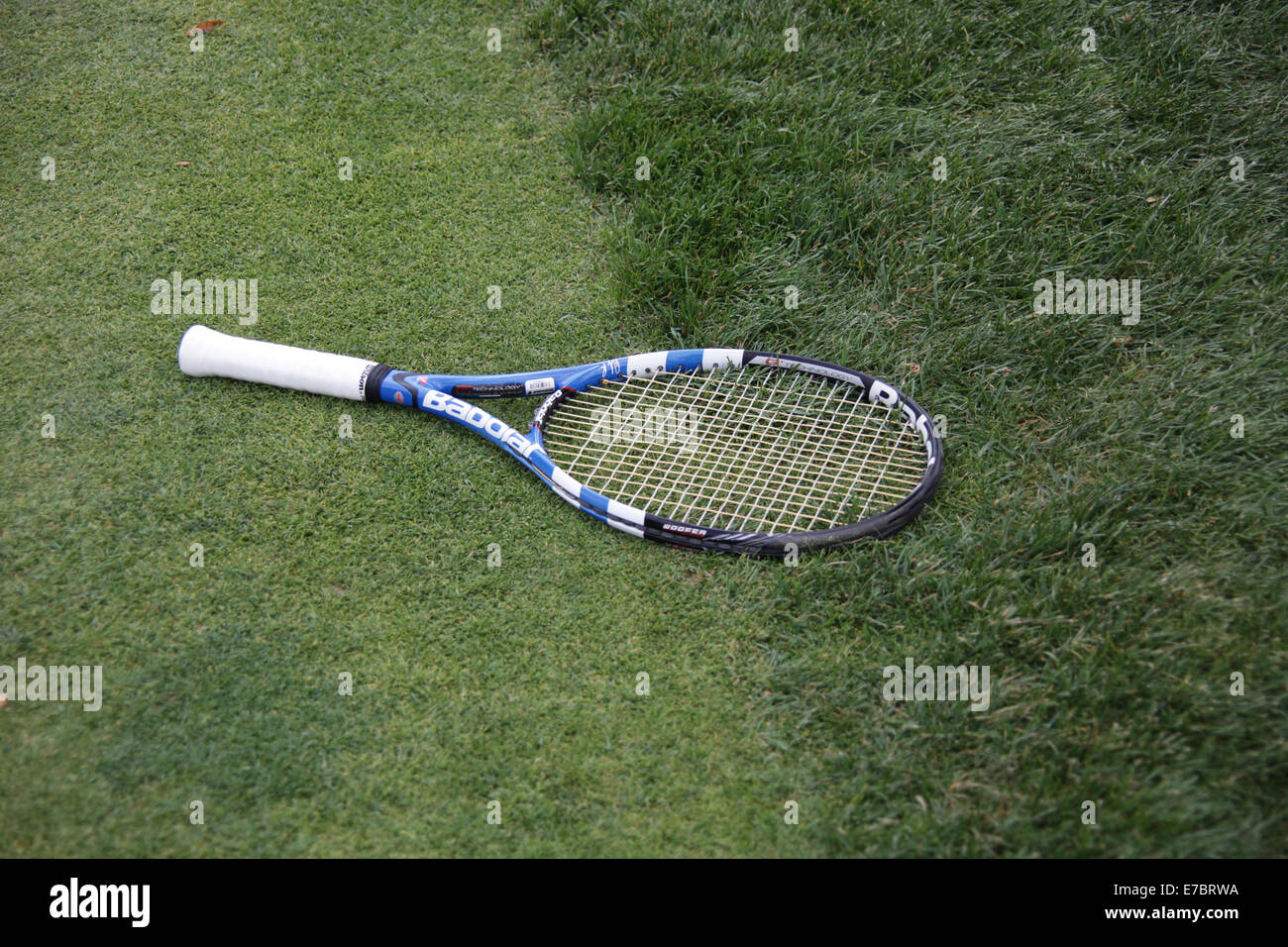 Babolat tennis racquet laying on green grass tennis court , USA, 2014 ...