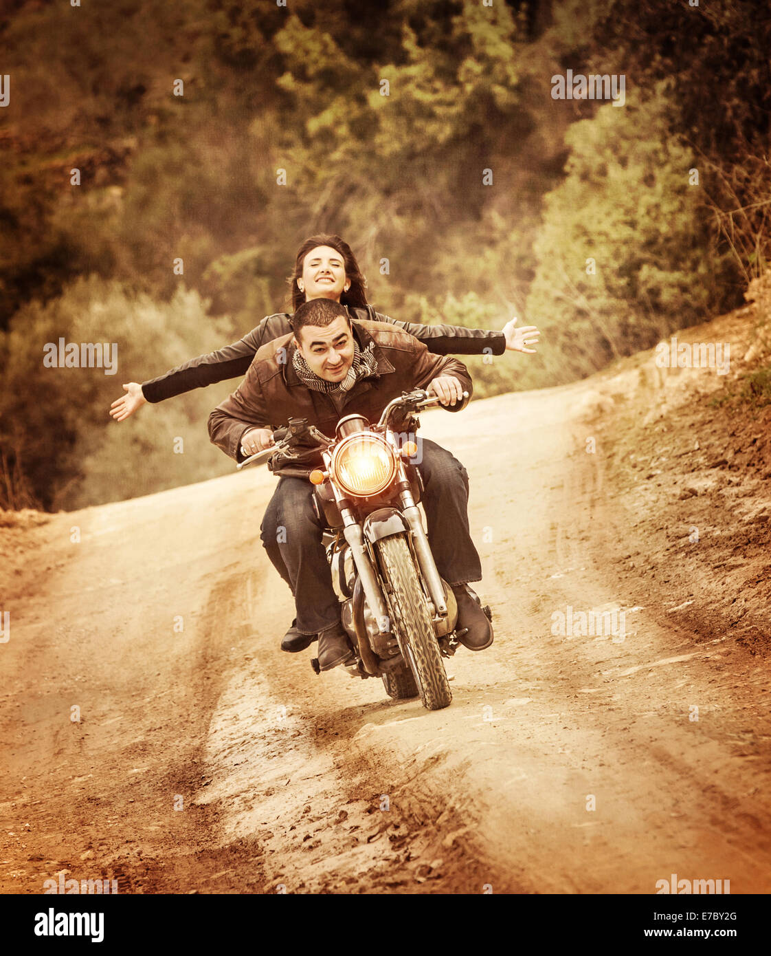 Sporty family traveling on motorbike, riding on motorcycle with raised ...