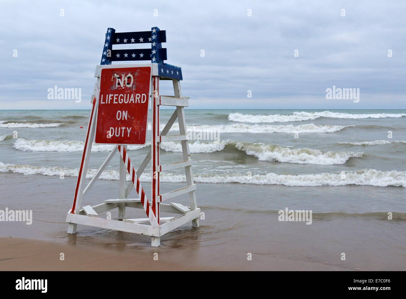 Empty lifeguard tower with No Lifeguard on Duty sign on deserted beach ...