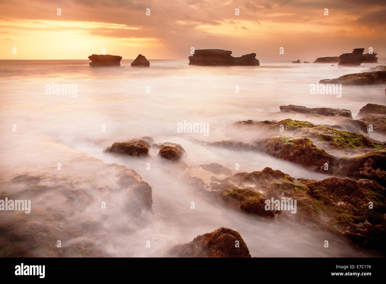 Long exposure seascape with superb ambient sunset and silhouetted sea ...