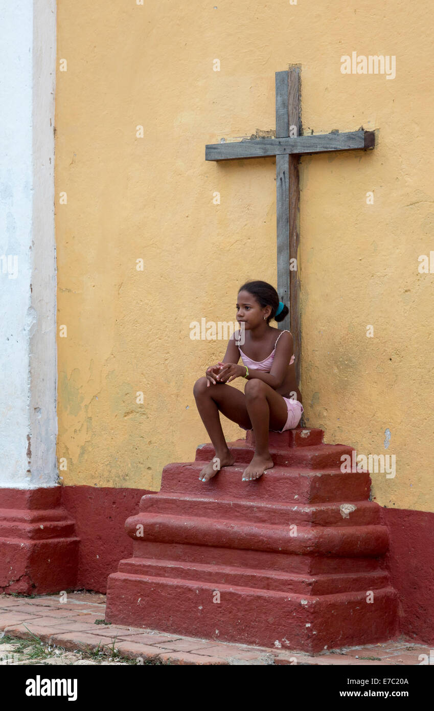 Cuban girl sitting on cross, Trinidad, Cuba Stock Photo - Alamy