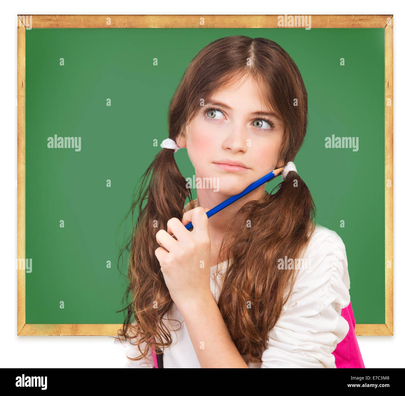 Closeup portrait of cute girl standing near chalkboard and try to ...