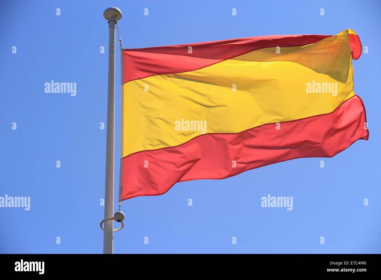Civil, commercial Spain flag without coat of arms to blue sky ...