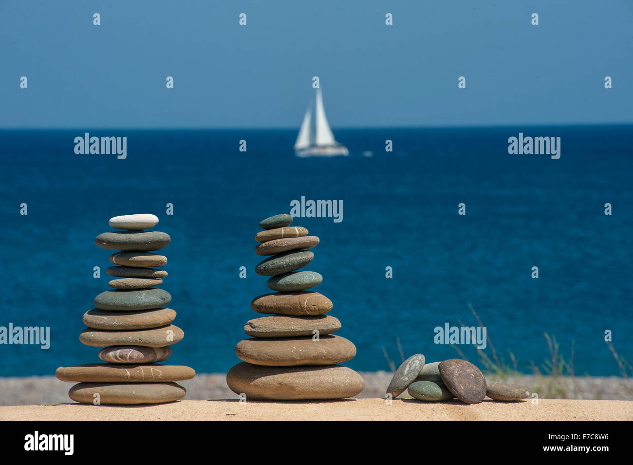 Two piles of pebbles on the coast with a blue sea Stock Photo - Alamy