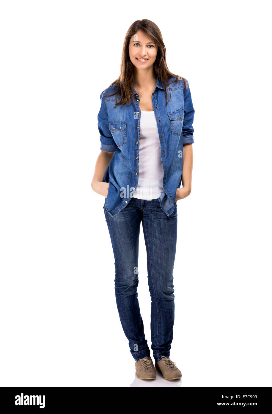 Beautiful woman standing over a white background with hands on the ...