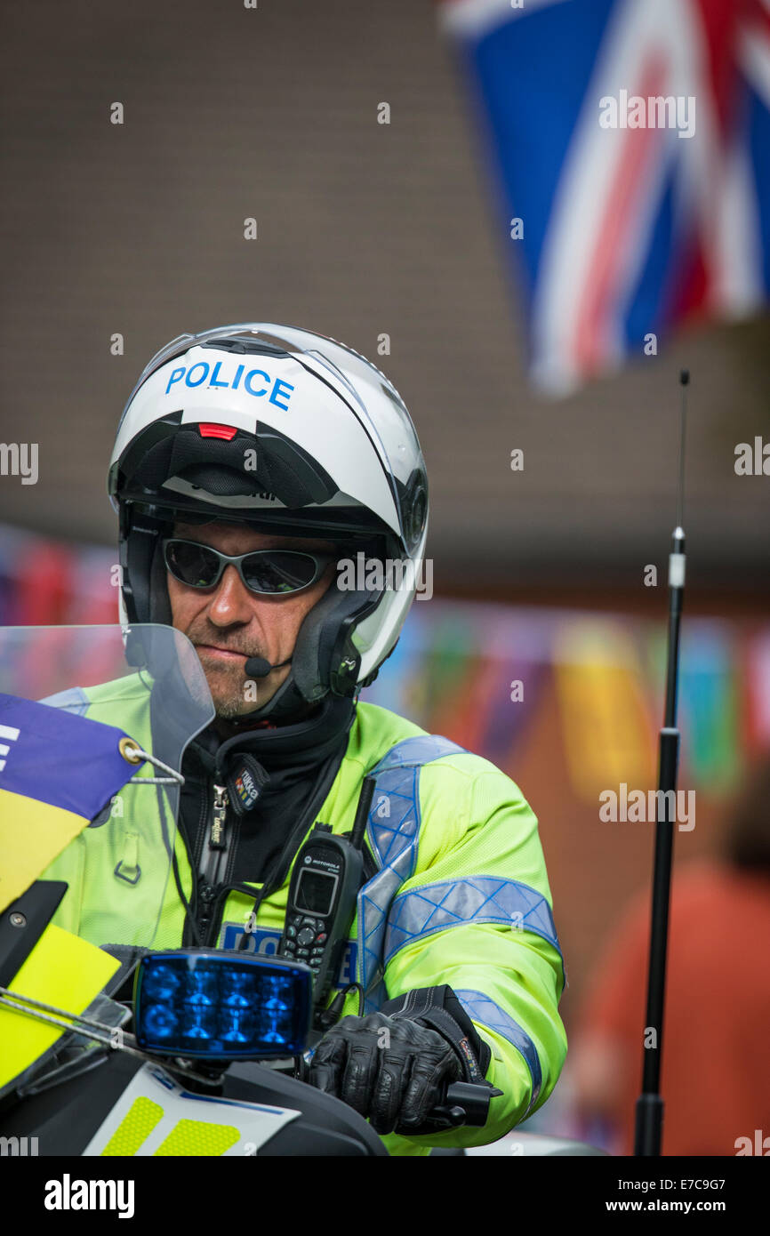 Fernhurst, UK. 13th Sep, 2014. A police motorcycle rider awaits the ...
