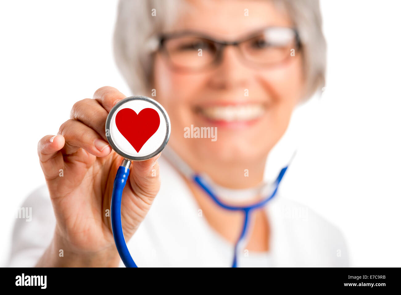 Happy old female doctor holding a stethoscope witha hearth on it ...