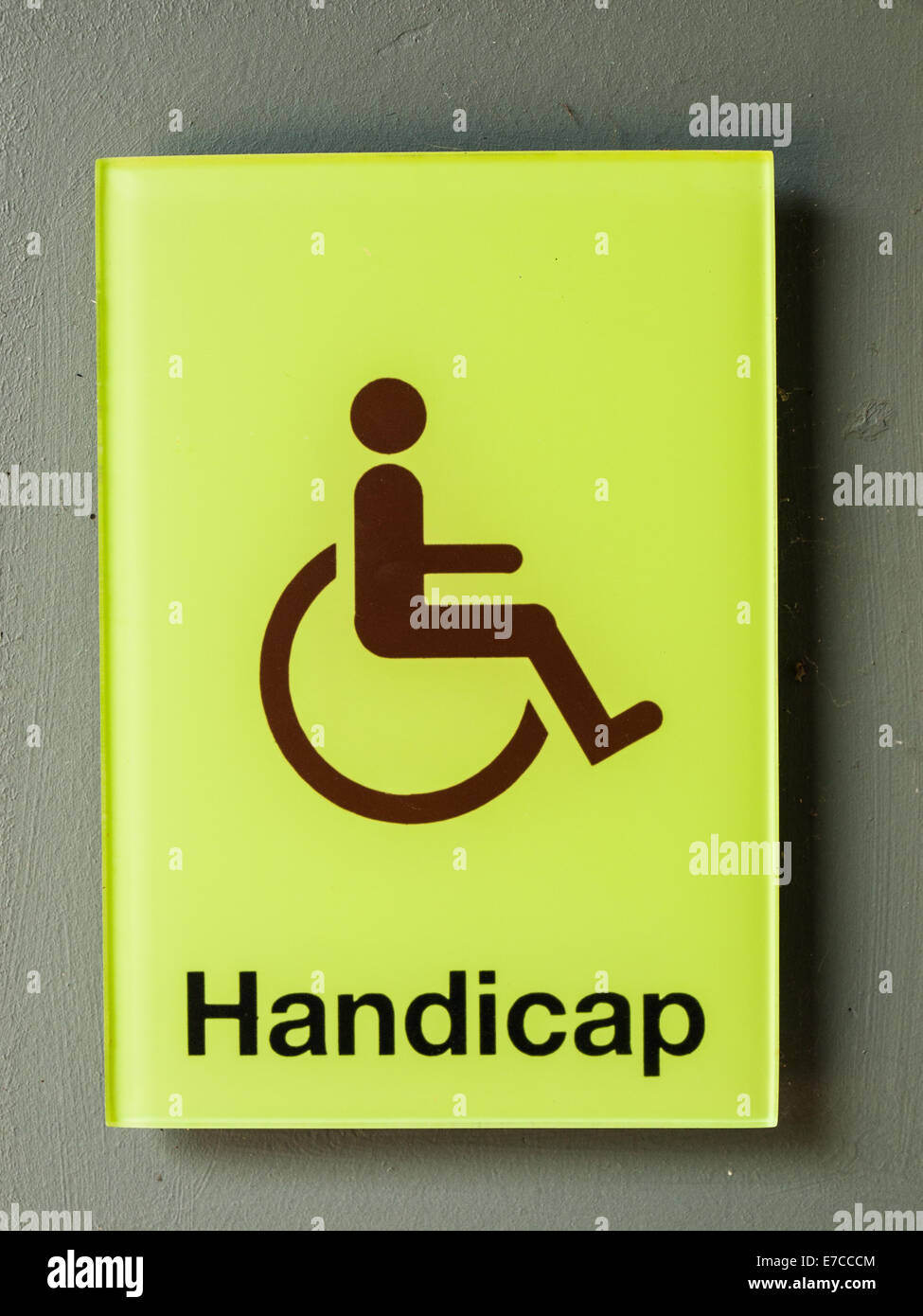 Green glass handicap sign on grey wall Stock Photo - Alamy