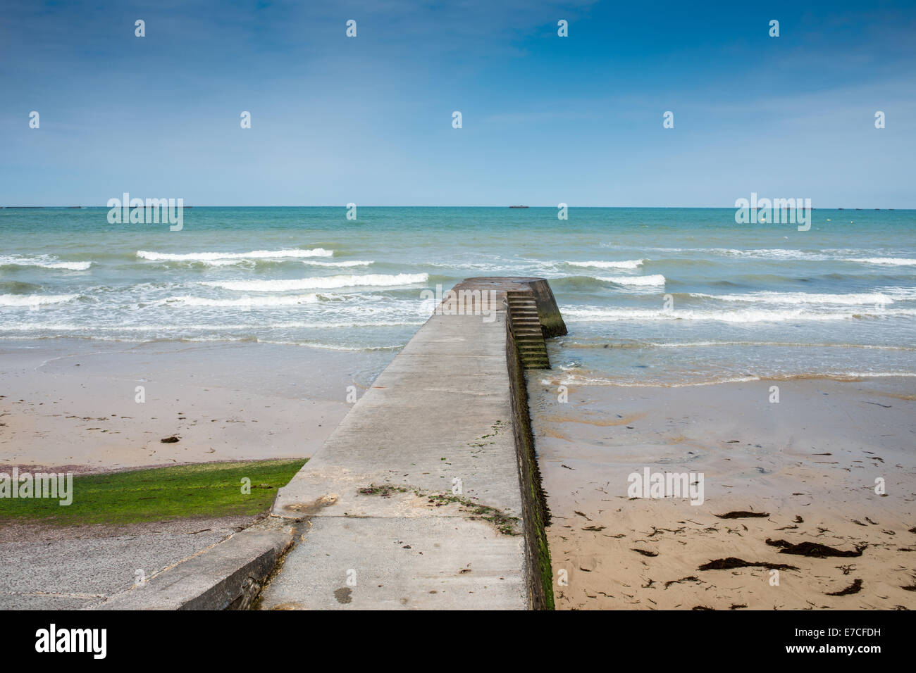 Arromanches les Bains beach with the remains of the Mulberry harbour in ...