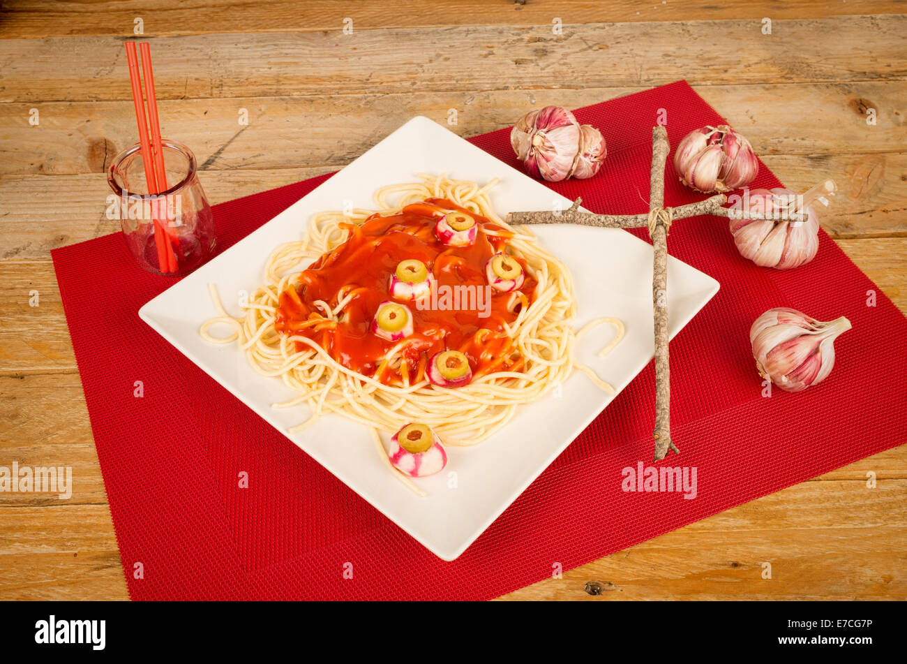 Portion of Halloween spaghetti with spooky eyes, a cross and garlic to ...