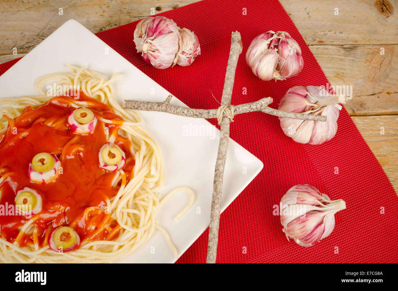Portion of Halloween spaghetti with spooky eyes, a cross and garlic to ...