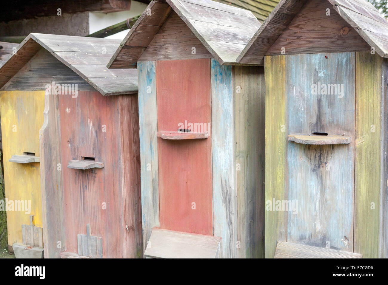Old hives apiaries, colored beehives, rural wooden beehive, painted ...