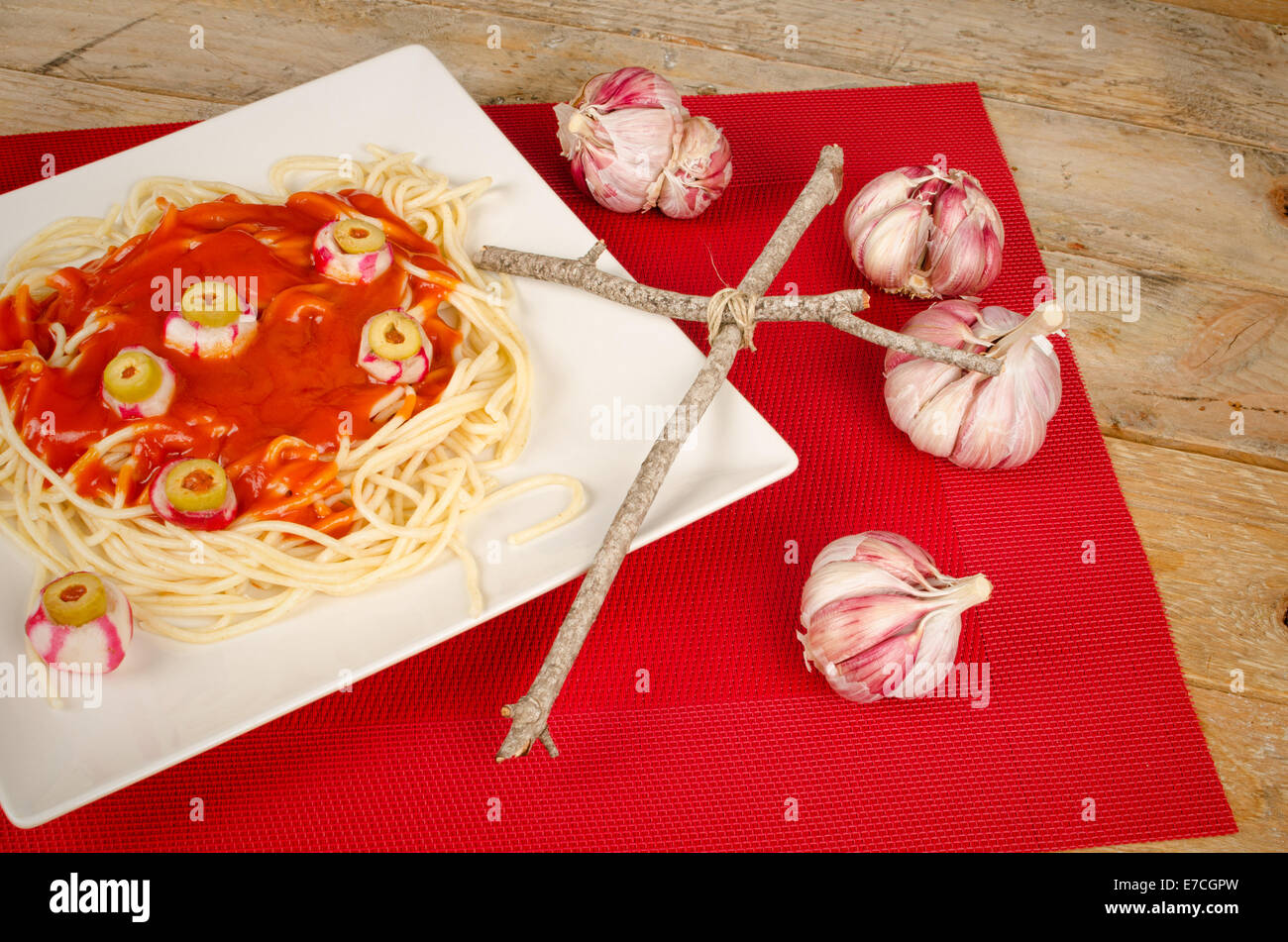 Portion of Halloween spaghetti with spooky eyes, a cross and garlic to ...
