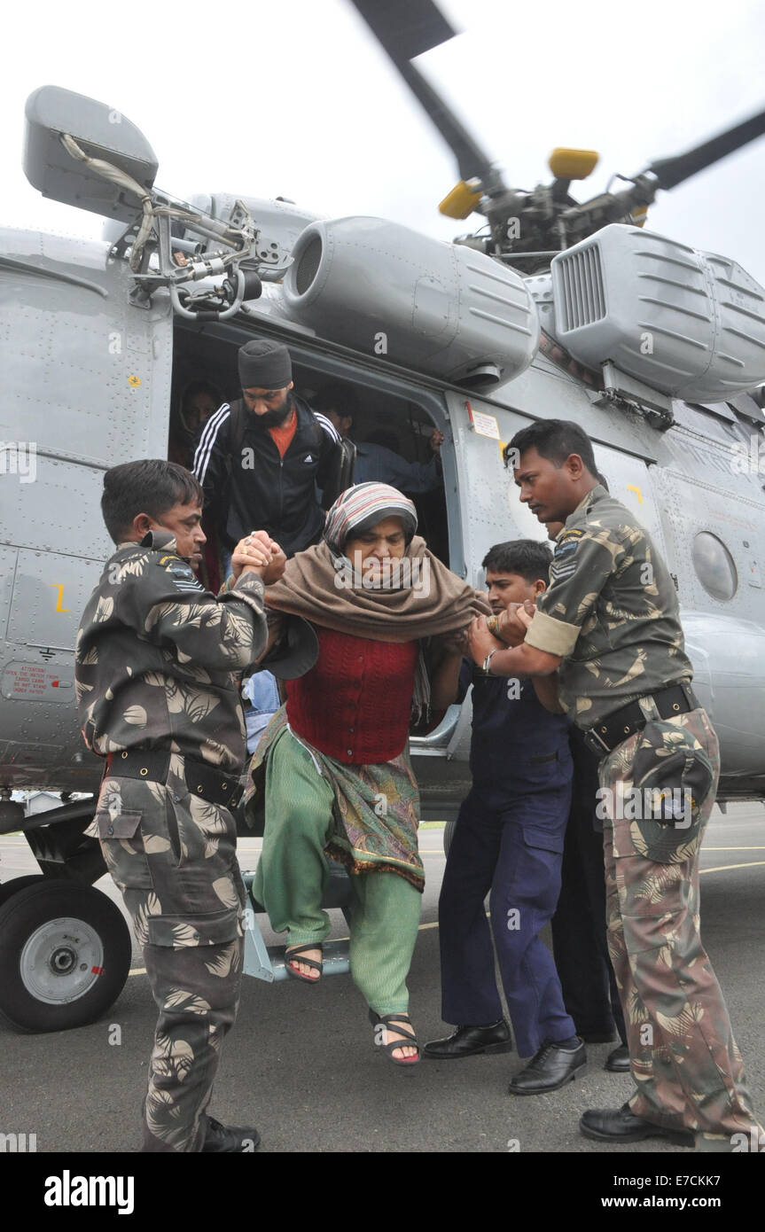 Indian Army soldier help an elderly woman alight from an IAF helicopter ...