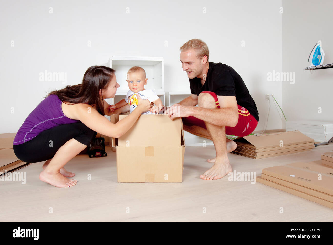 Young Family with a Baby Moving in a New Apartment Stock Photo - Alamy