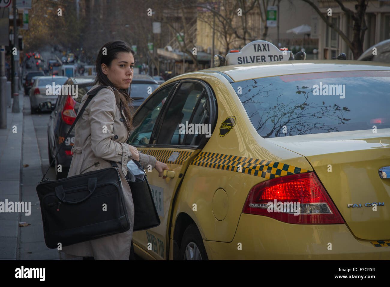 Woman getting into taxi hi-res stock photography and images - Alamy