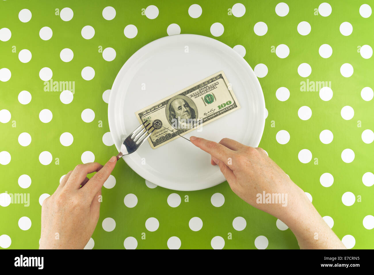 Woman eating hundred dollar bill for dinner, top view Stock Photo - Alamy
