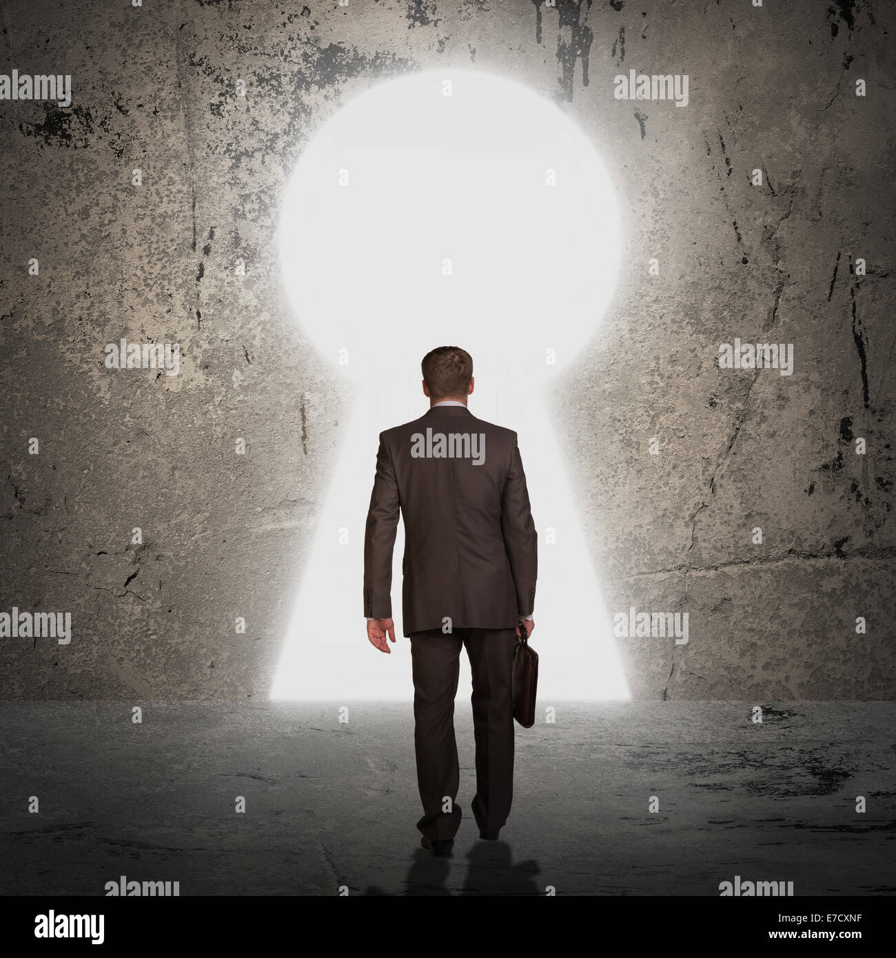 Businessman with briefcase stepping through door in form of keyhole ...