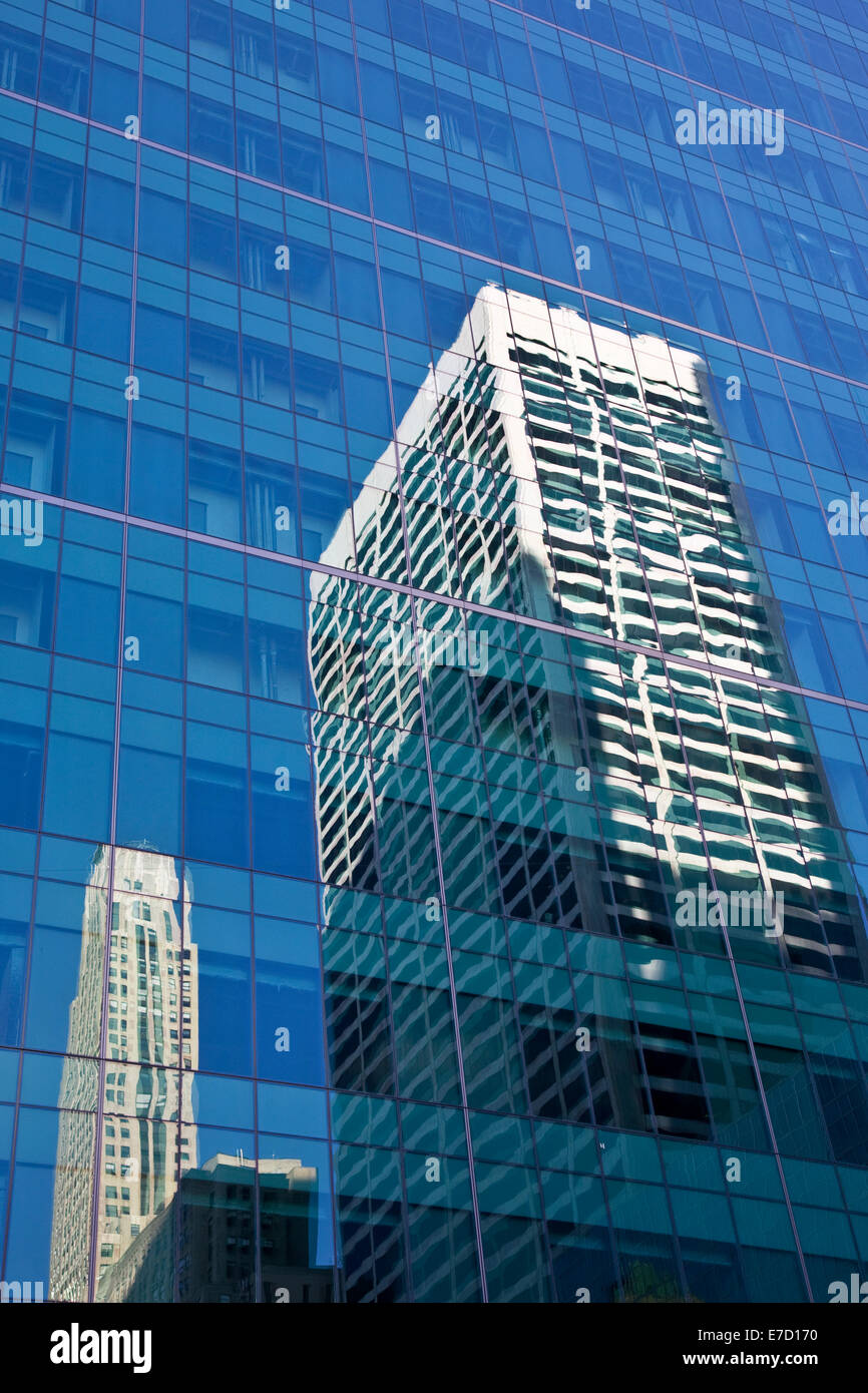 Skyscrapers reflected in the glass surface of another high rise ...