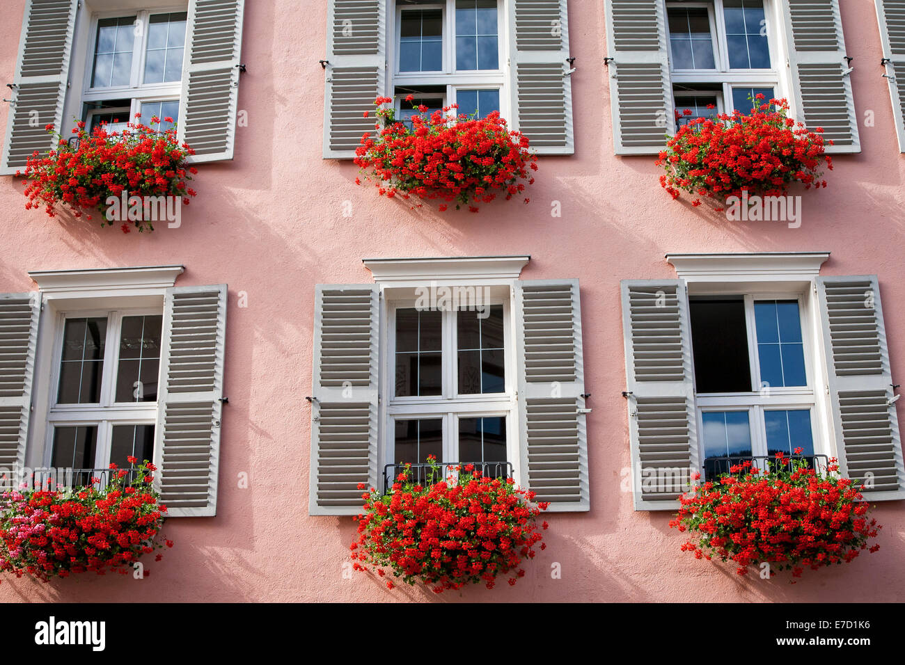 Flower boxes adorn shuttered windows in Kitzbuhl, Austria Stock Photo ...