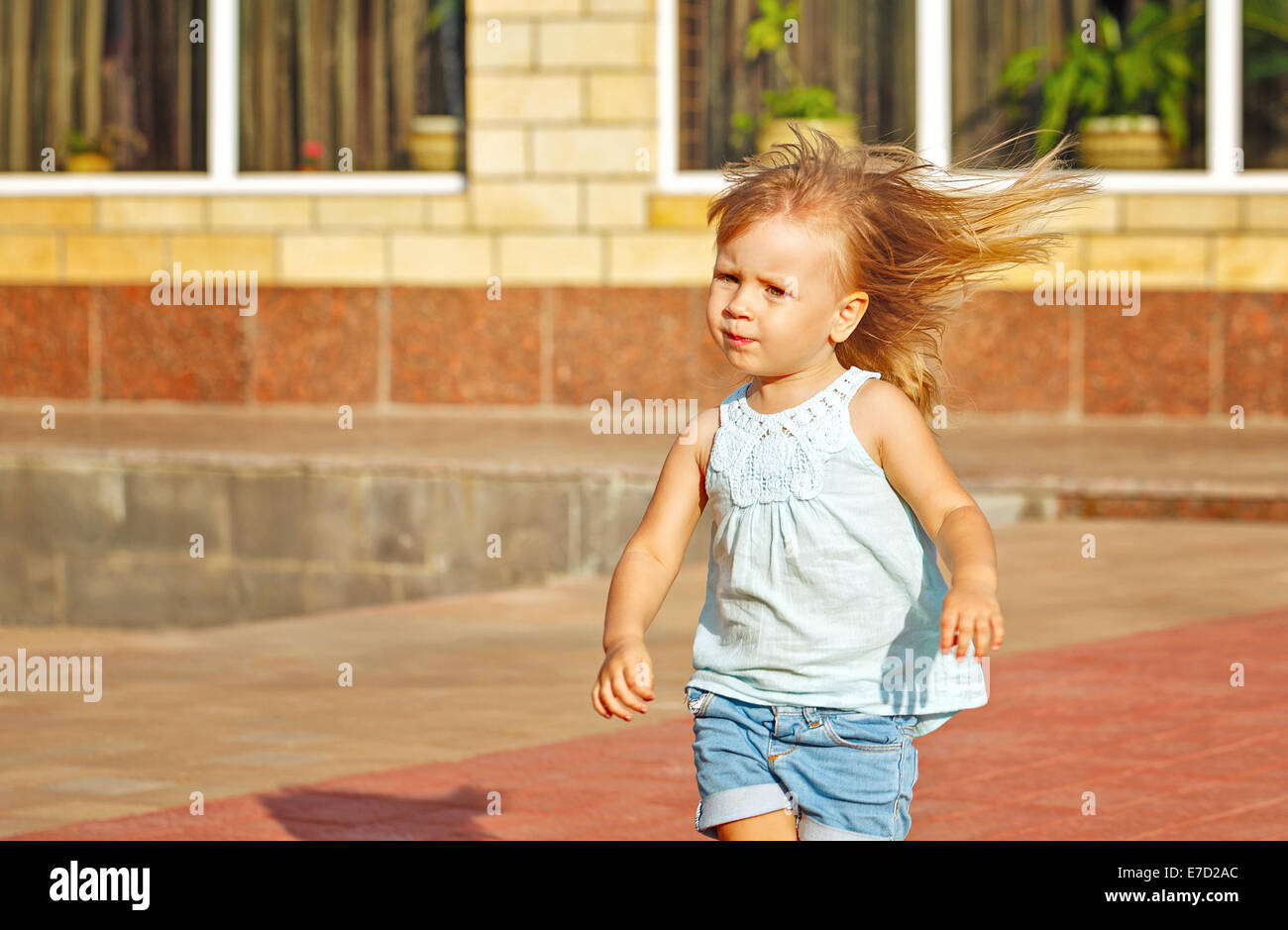 Little cute girl running and her hair develop Stock Photo - Alamy