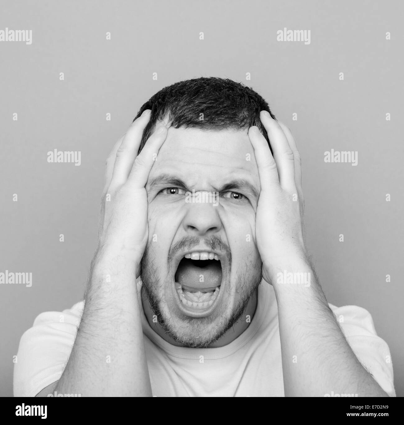Portrait of angry man screaming and pulling hair - Monocrome or black ...