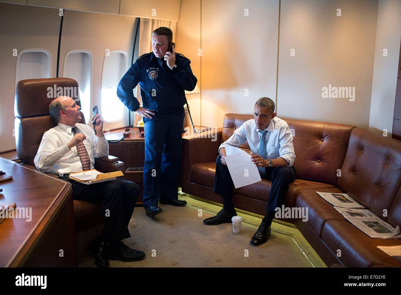 US President Barack Obama reads a document between phone calls aboard ...