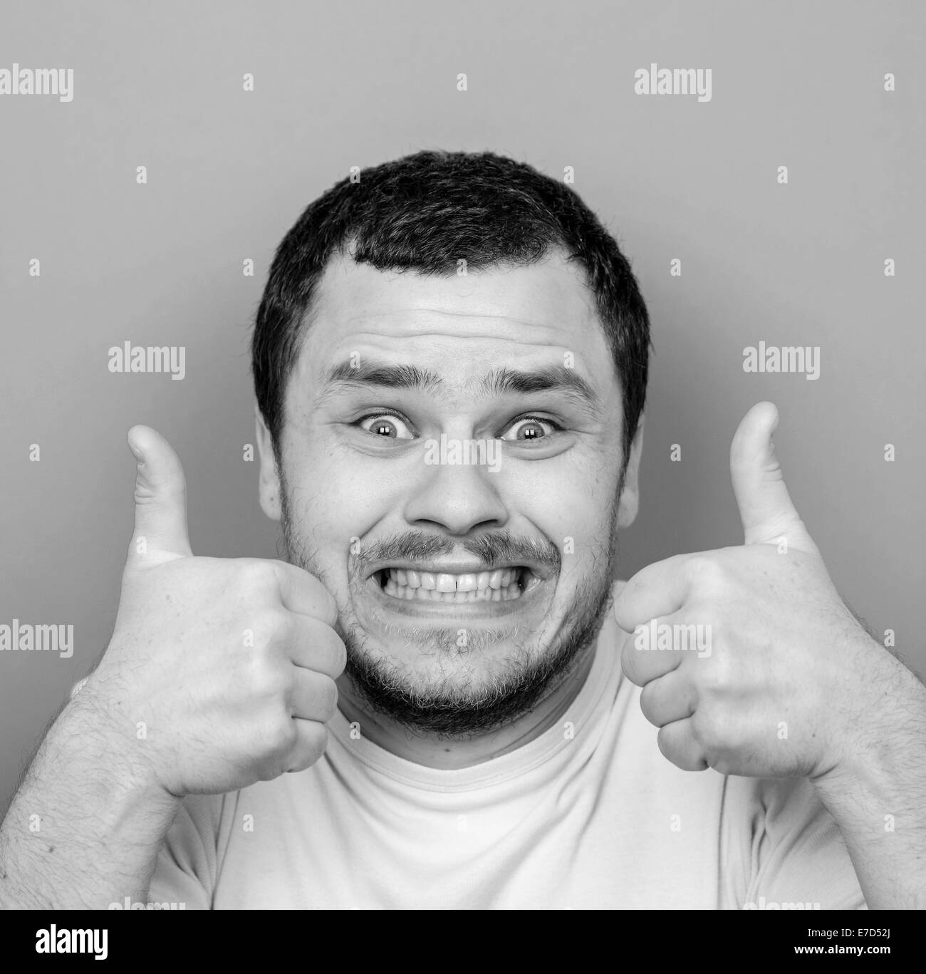 Portrait of with funny expression holding thumbs up - Monocrome or ...