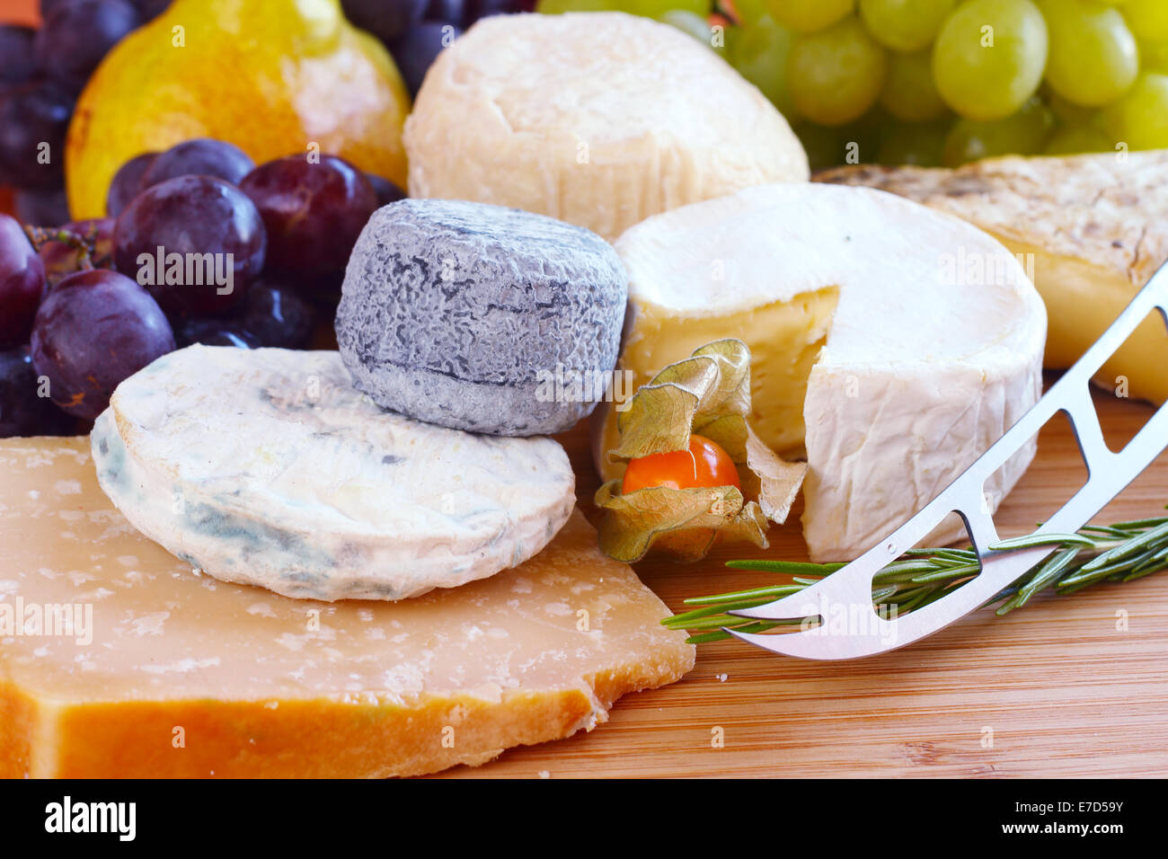 French cheese composition on wooden plank table Stock Photo - Alamy