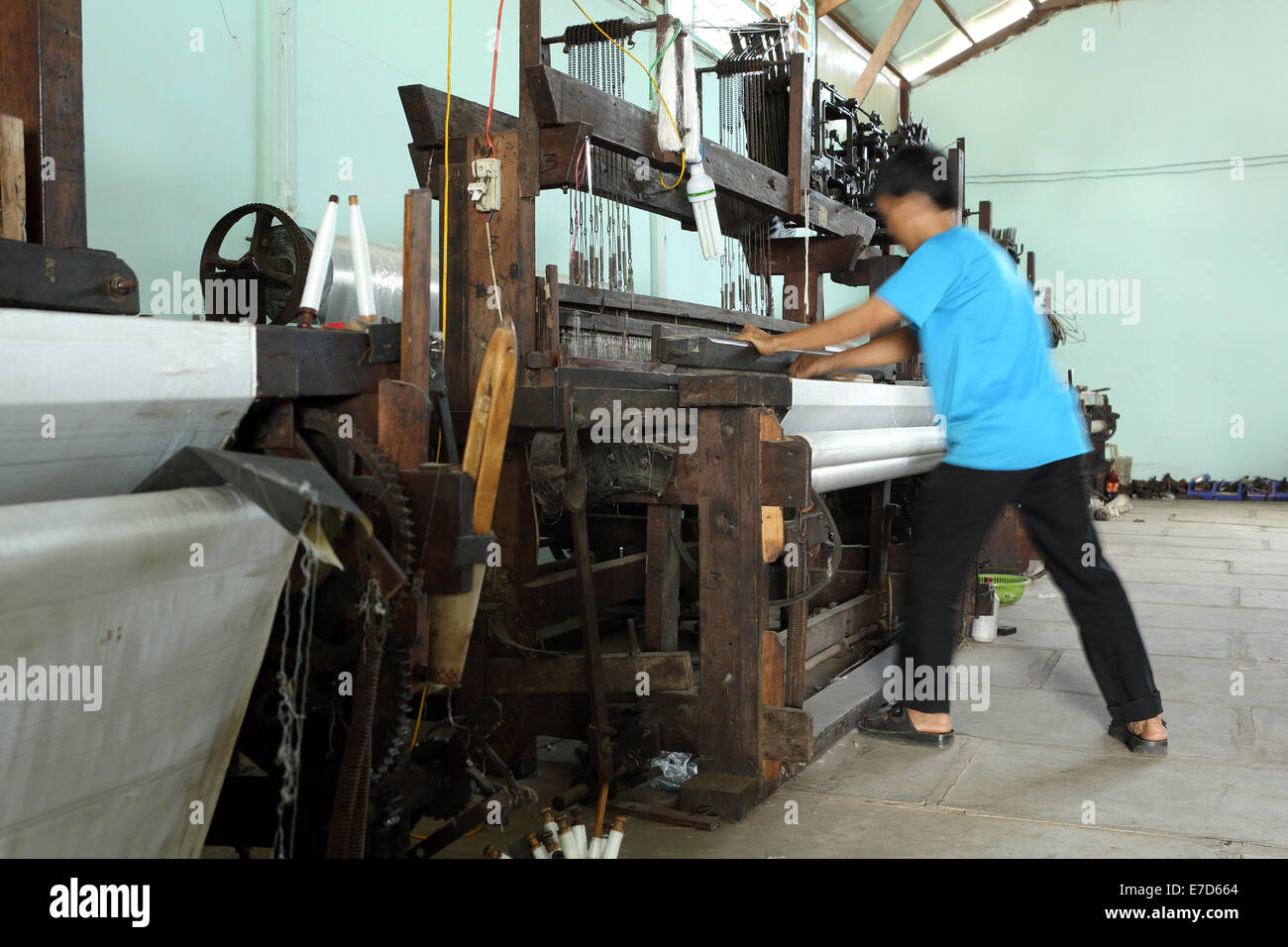 A man by a silk weaving loom in Tan Chau, Vietnam Stock Photo - Alamy
