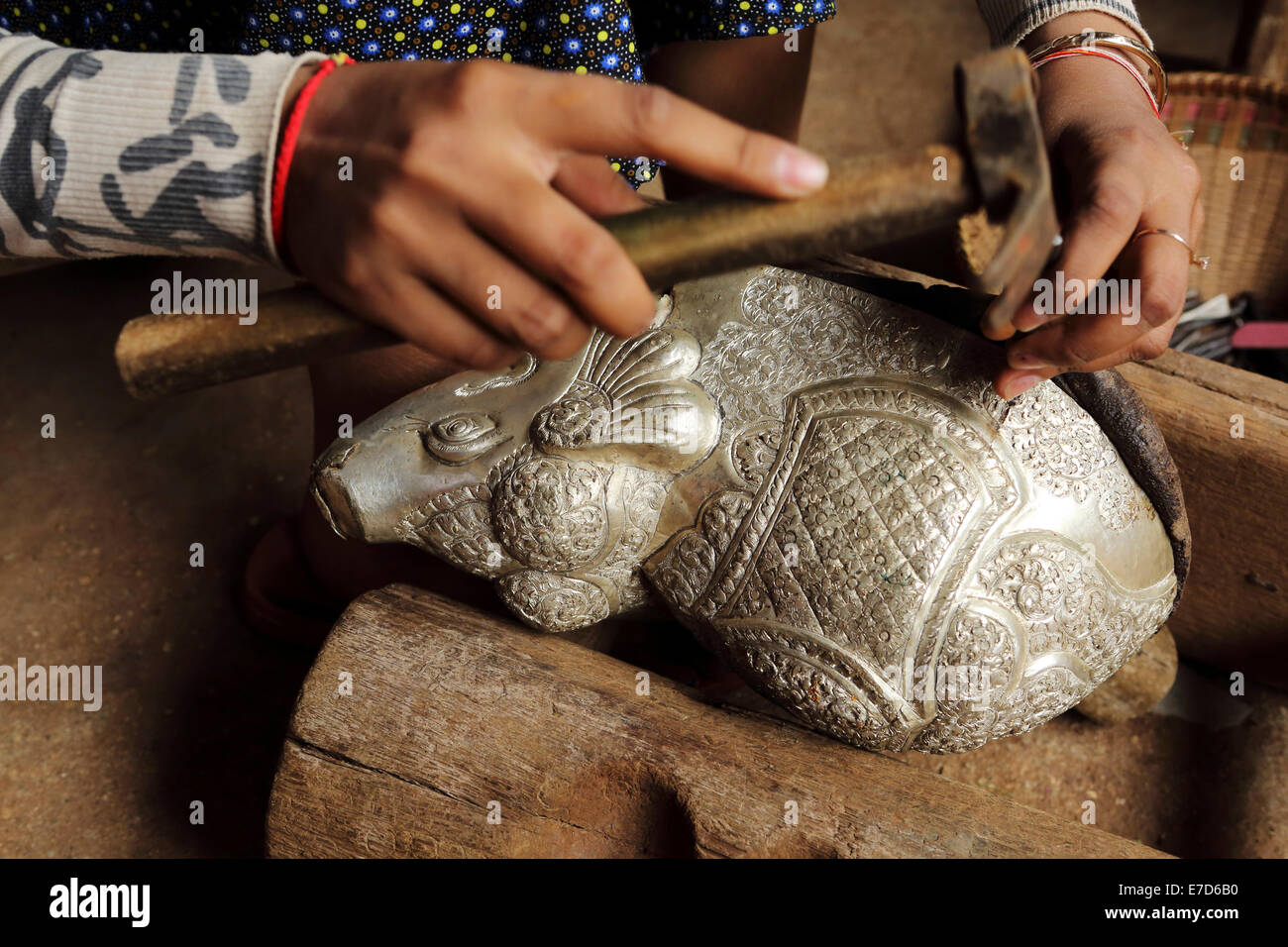 A silversmith at work in Kampong Trolach, Cambodia. The village is ...