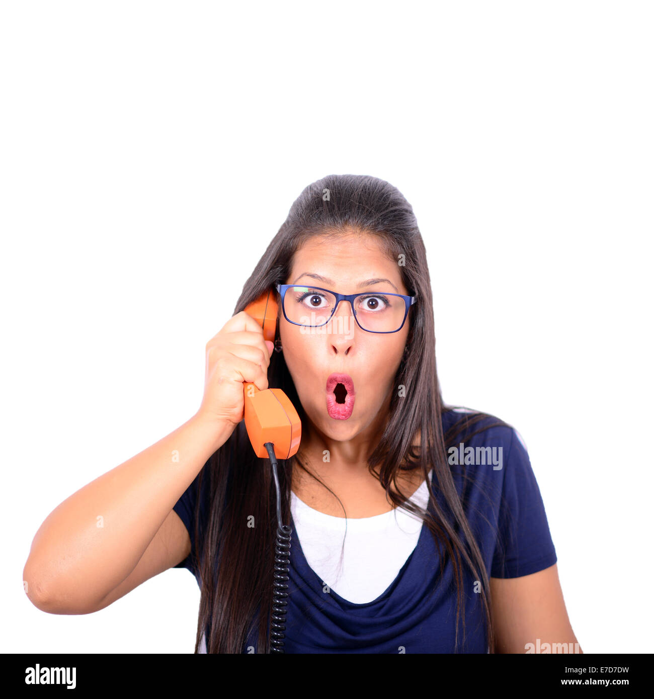 Portrait of young female in shock while talking on phone having ...
