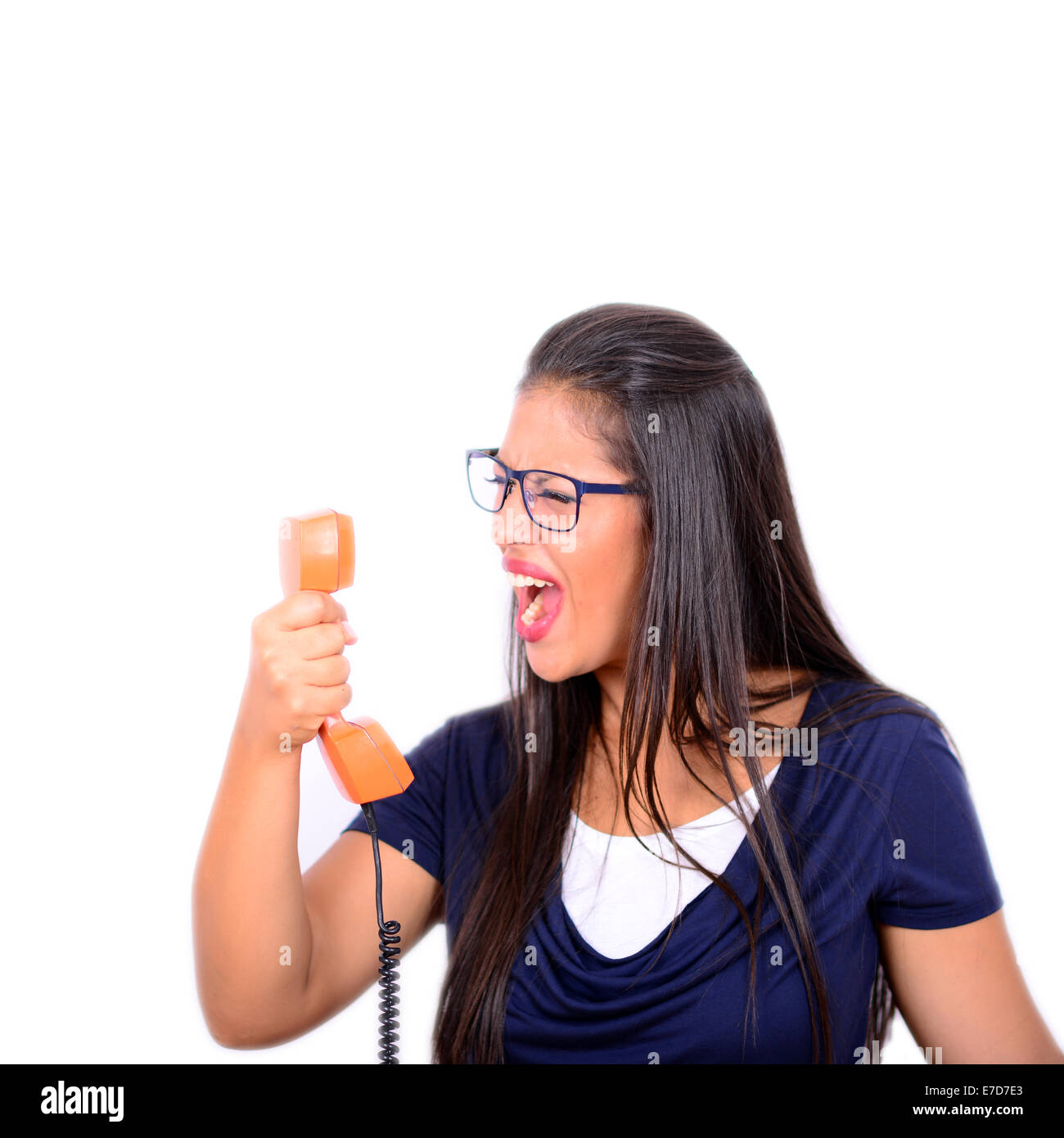 Portrait of young female yelling at phone against white background ...
