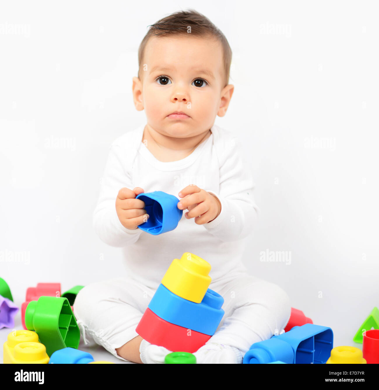 Beautiful baby girl with colorful toys - Studio shot Stock Photo - Alamy