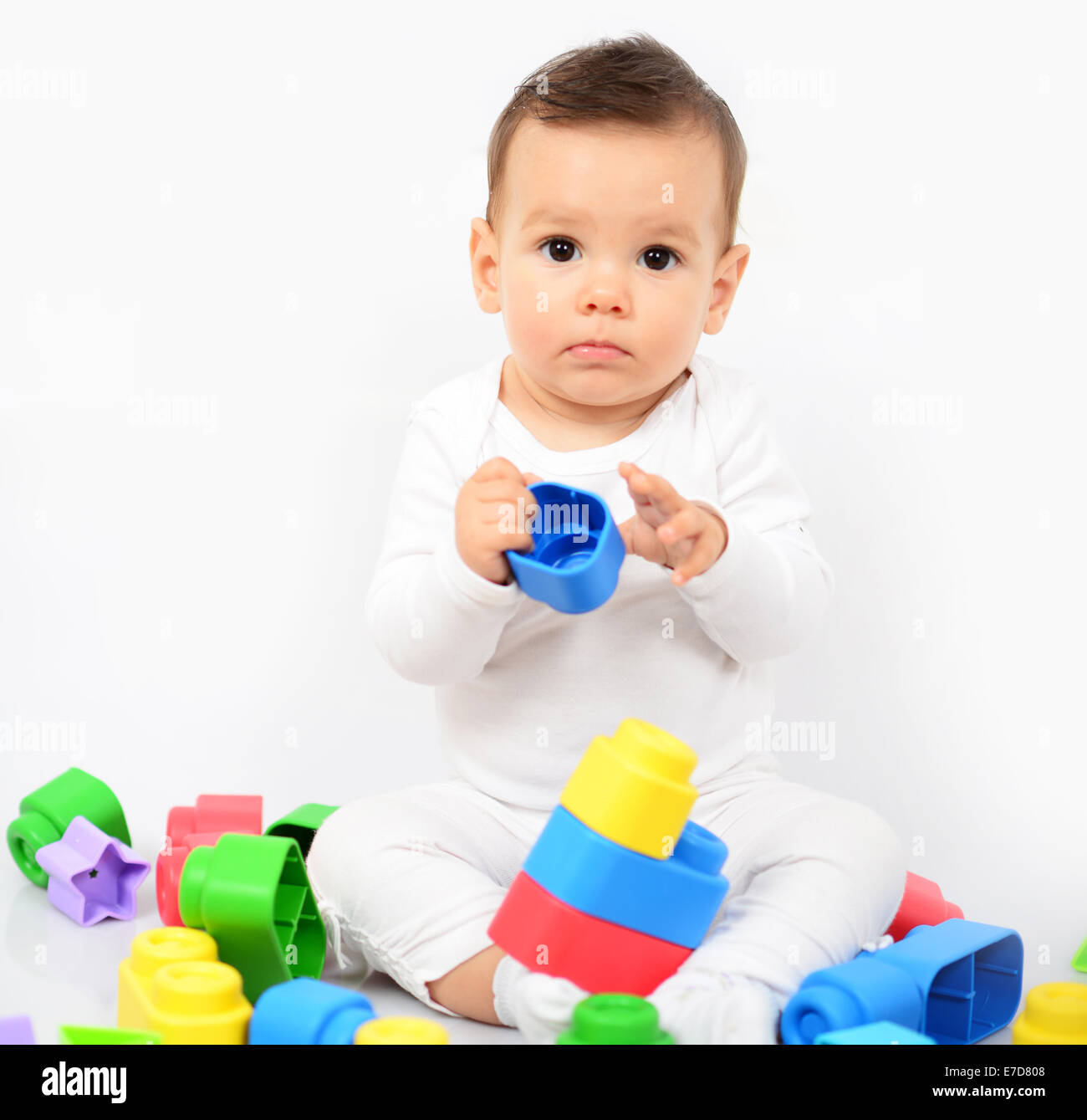 Beautiful baby girl with colorful toys - Studio shot Stock Photo - Alamy