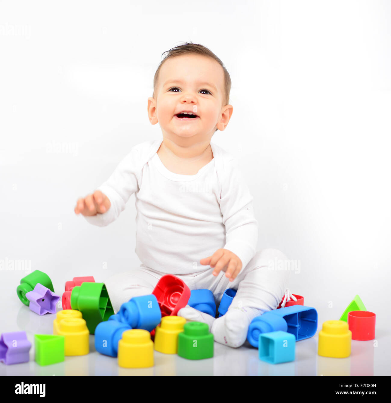 Beautiful baby girl with colorful toys - Studio shot Stock Photo - Alamy