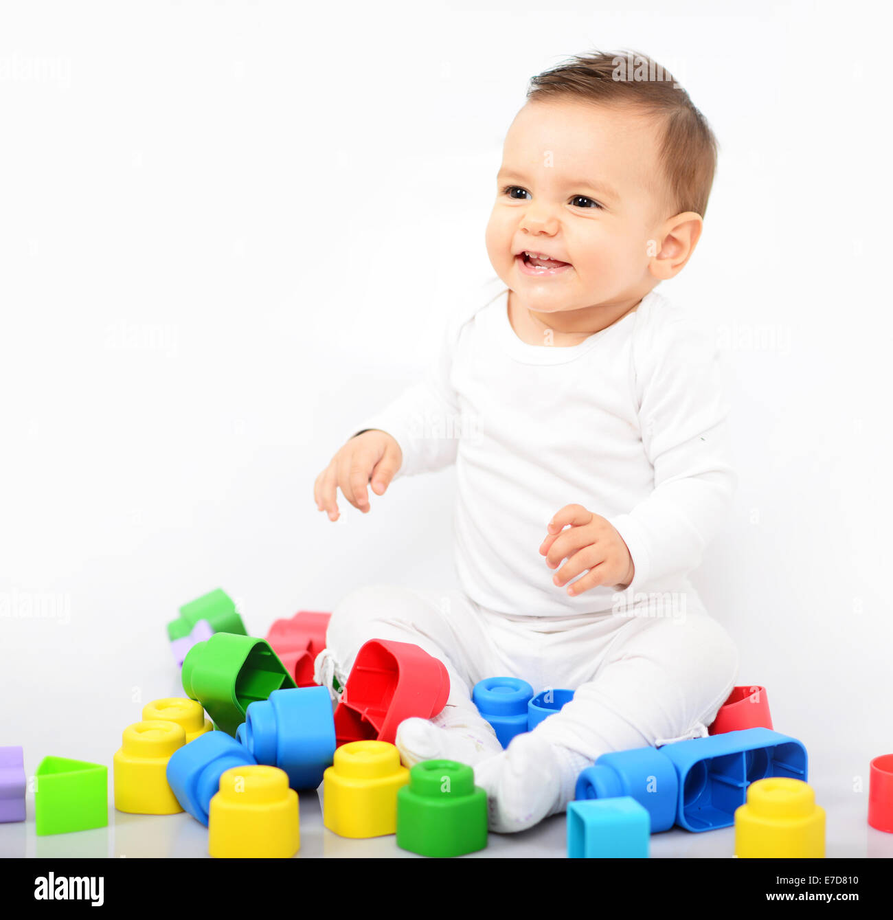 Beautiful baby girl with colorful toys - Studio shot Stock Photo - Alamy