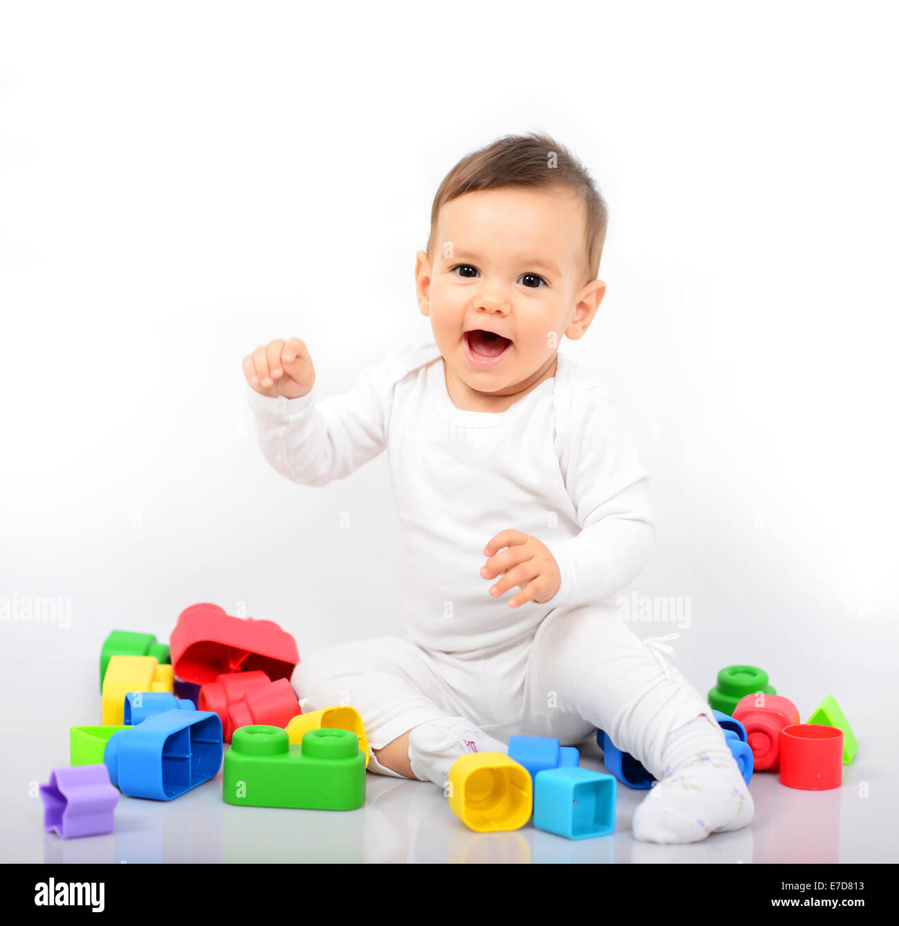 Beautiful baby girl with colorful toys - Studio shot Stock Photo - Alamy