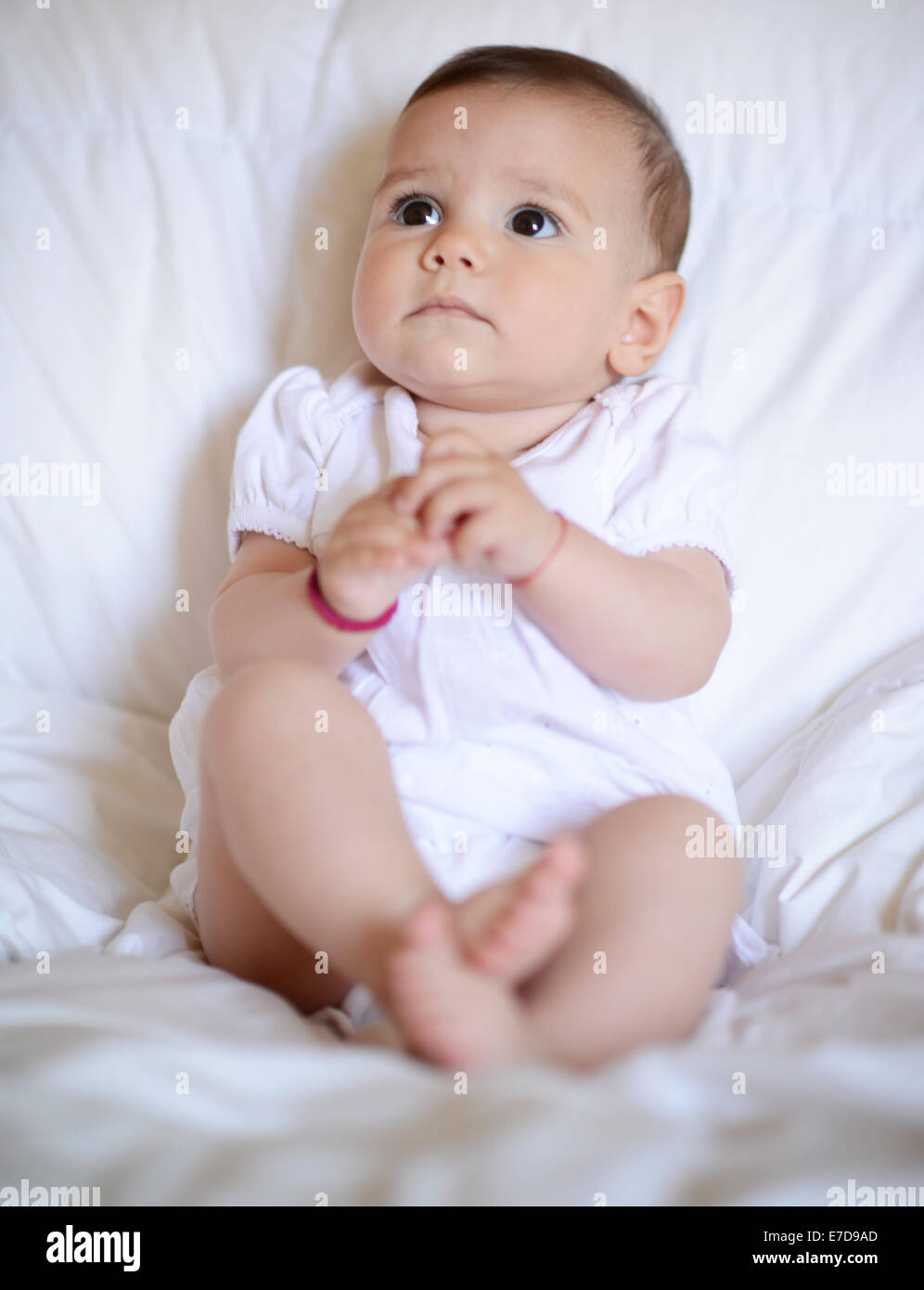 Beautiful baby girl looking at camera Stock Photo - Alamy