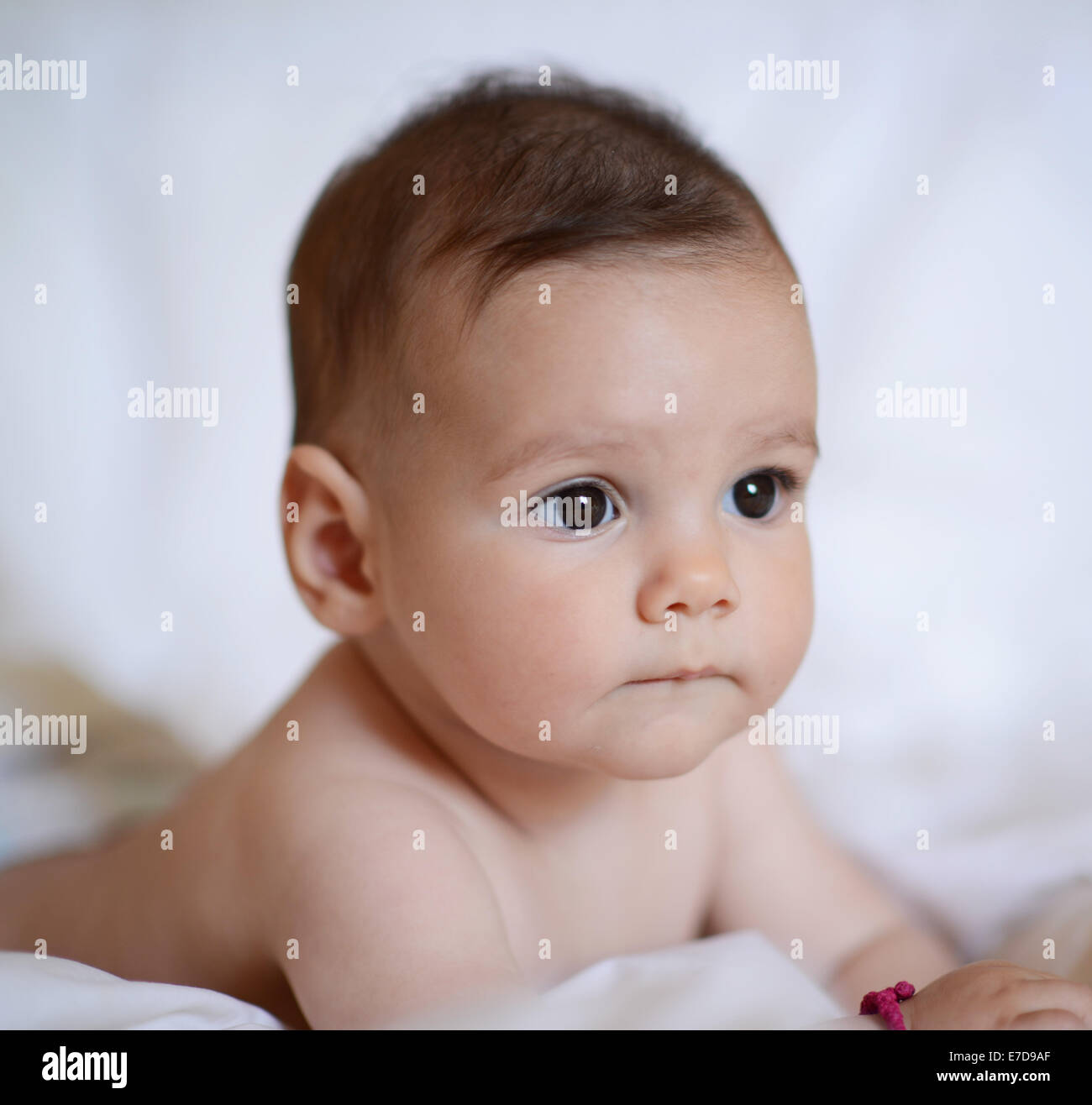 Beautiful baby girl looking at camera Stock Photo - Alamy