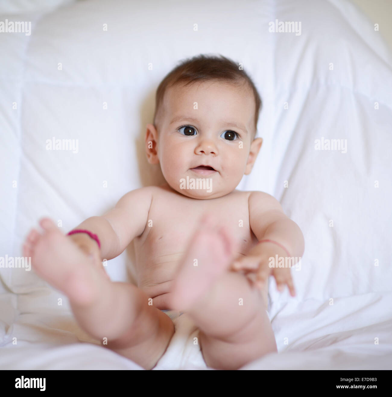 Beautiful baby girl looking at camera Stock Photo - Alamy