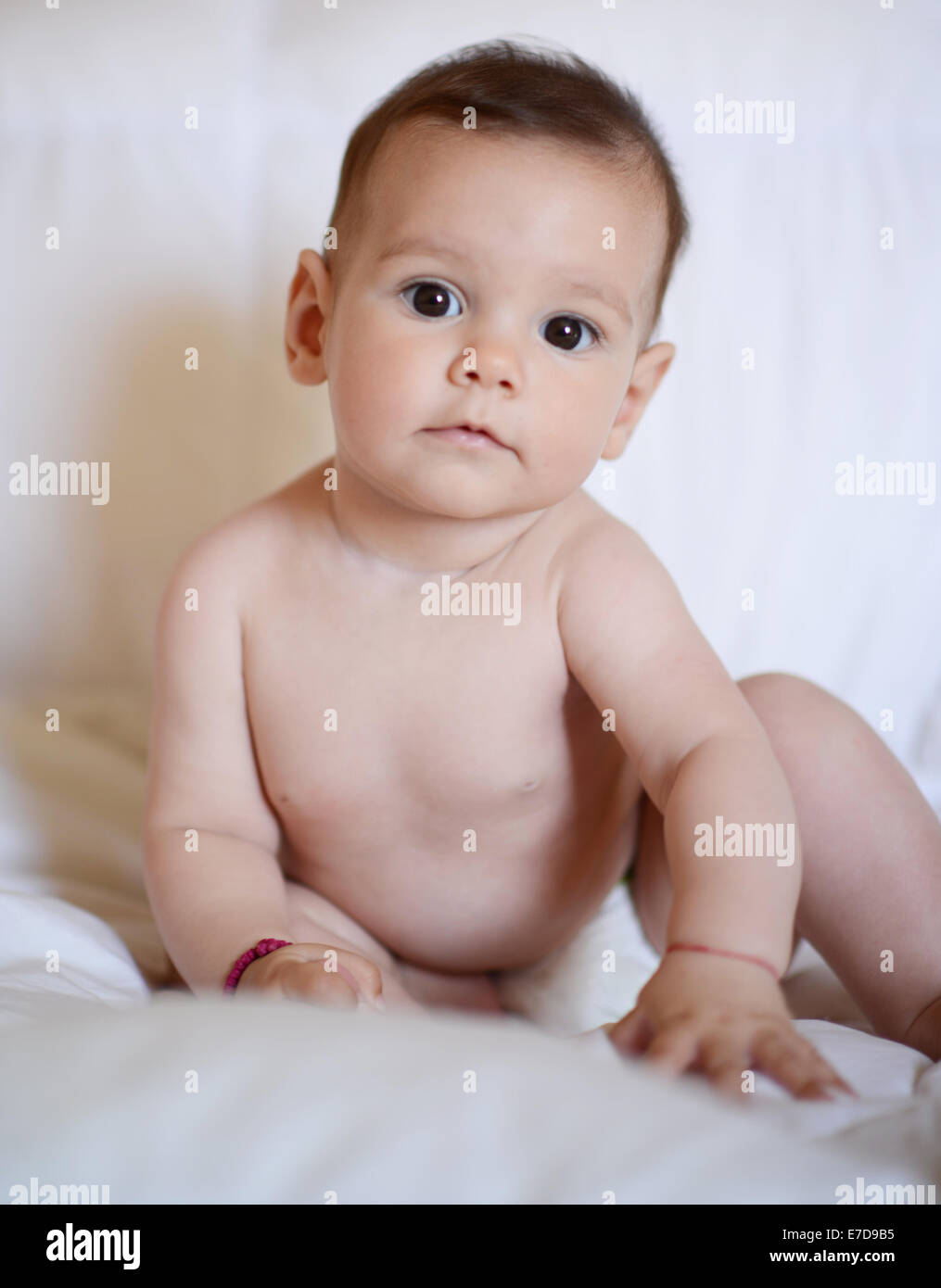 Beautiful baby girl looking at camera Stock Photo - Alamy