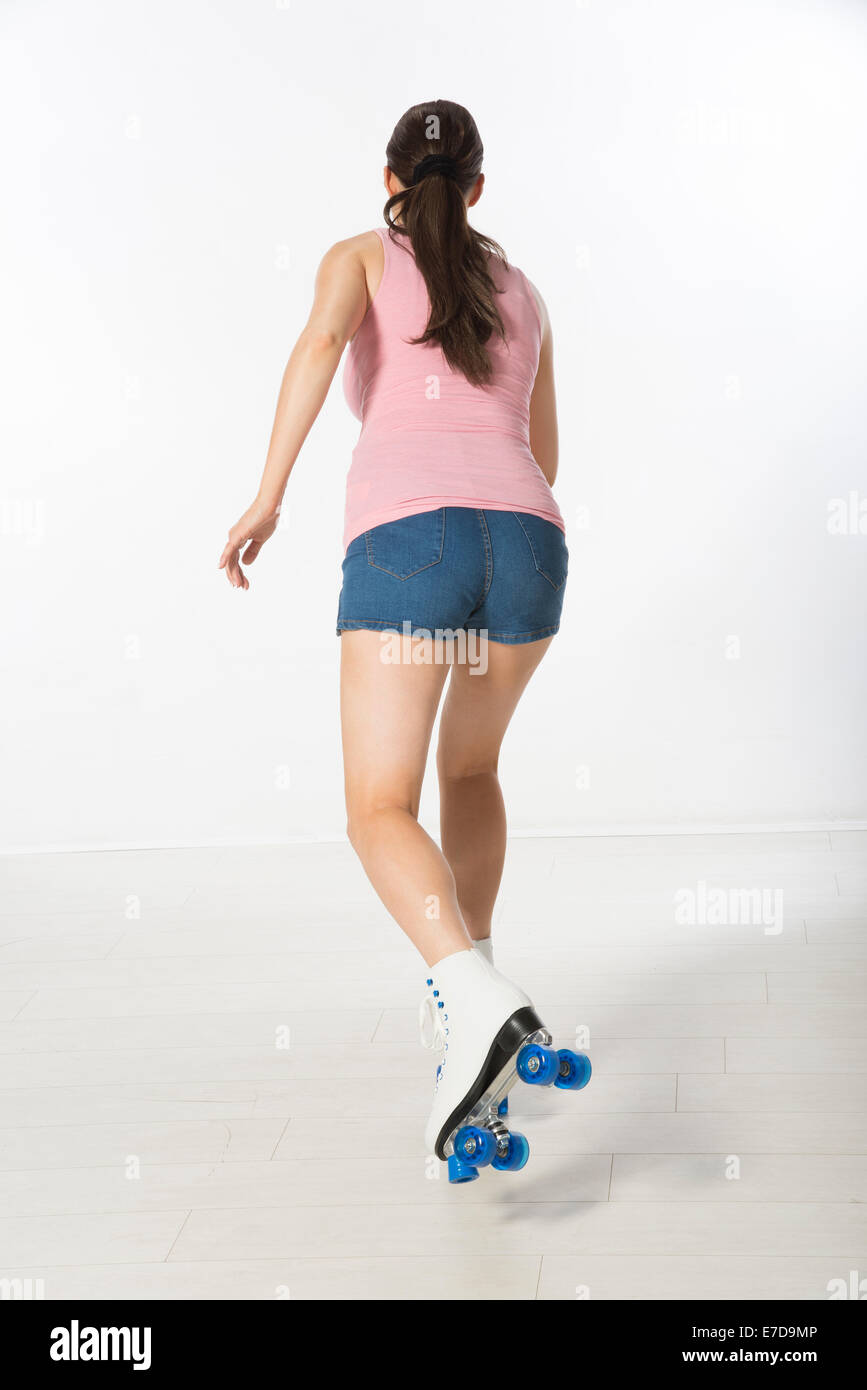 Rear view of a roller skater skating on quad skates Stock Photo - Alamy