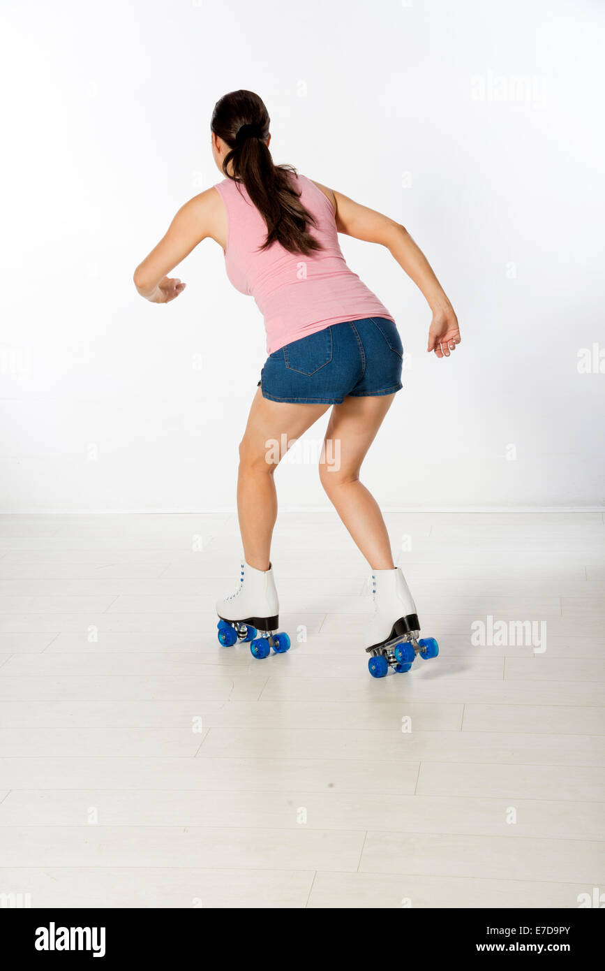 Rear view of a roller skater skating on quad skates Stock Photo - Alamy