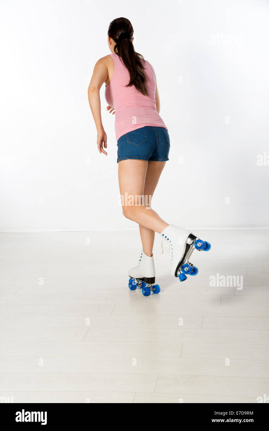Rear view of a roller skater skating on quad skates Stock Photo - Alamy