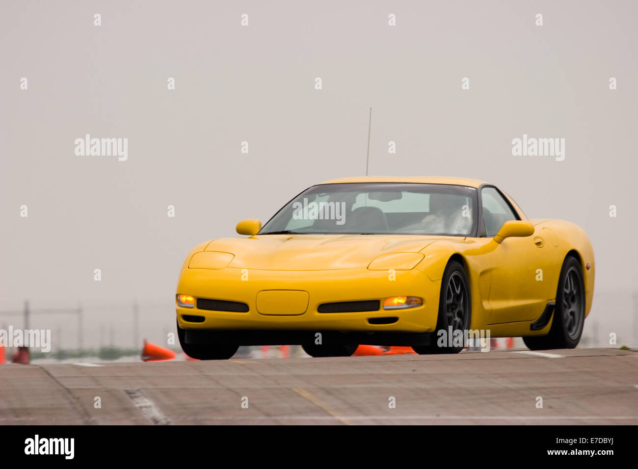 A 2001 Yellow Chevrolet Corvette Z06 in an autocross race at a regional ...