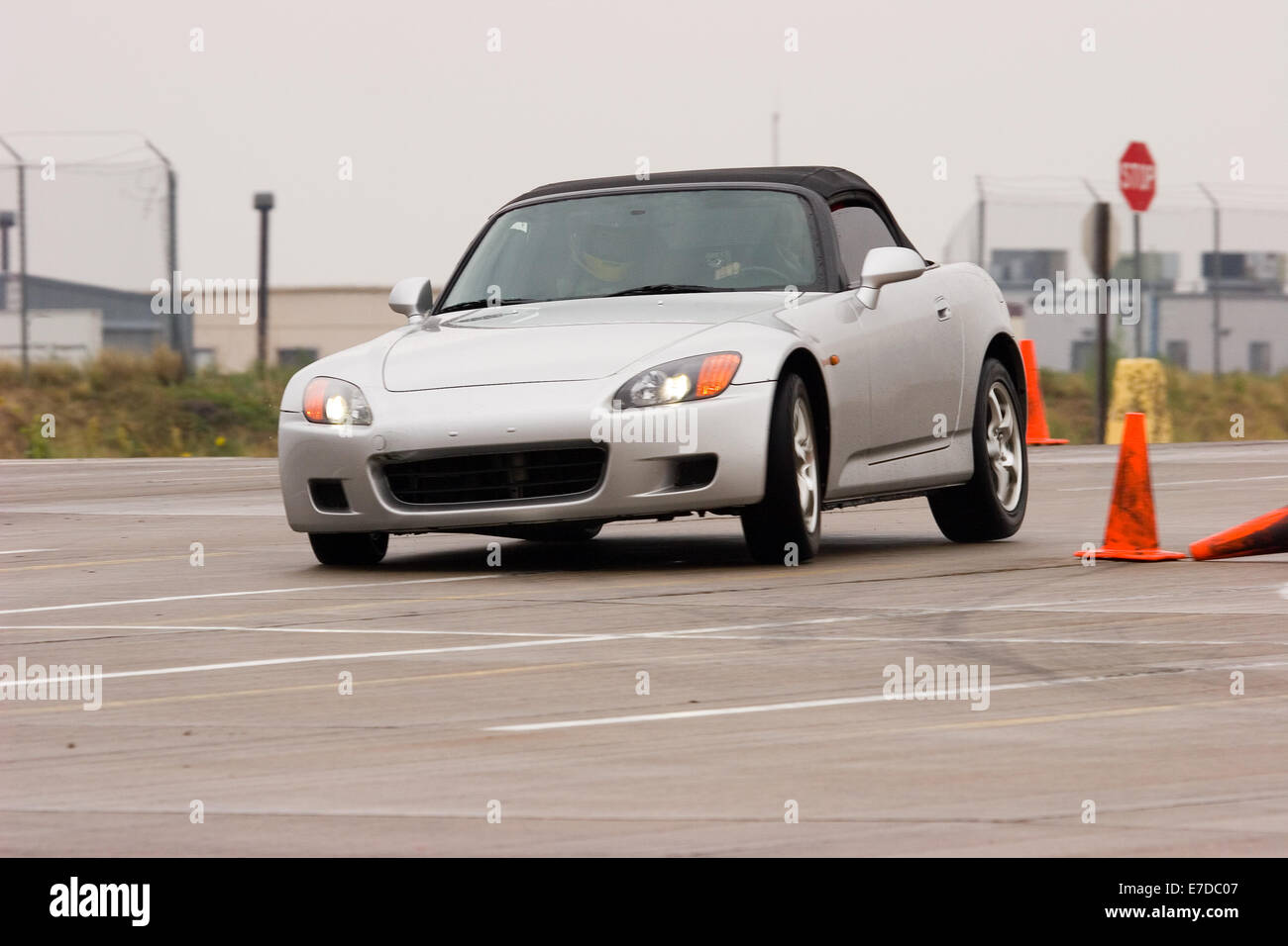 A gray convertible Honda S2000 sports car in an autocross race at a ...