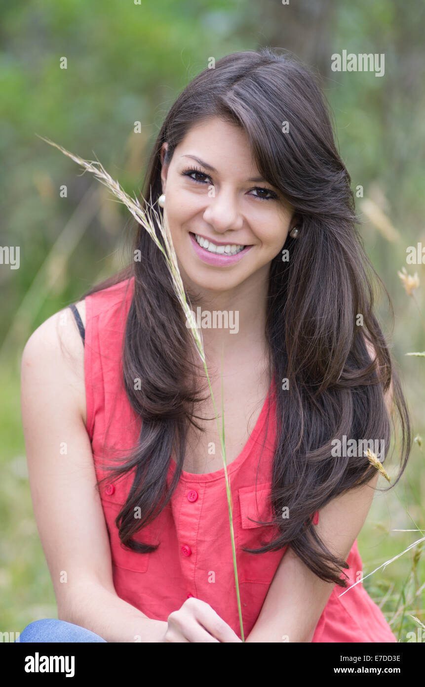 young girl sitting in a field Stock Photo - Alamy