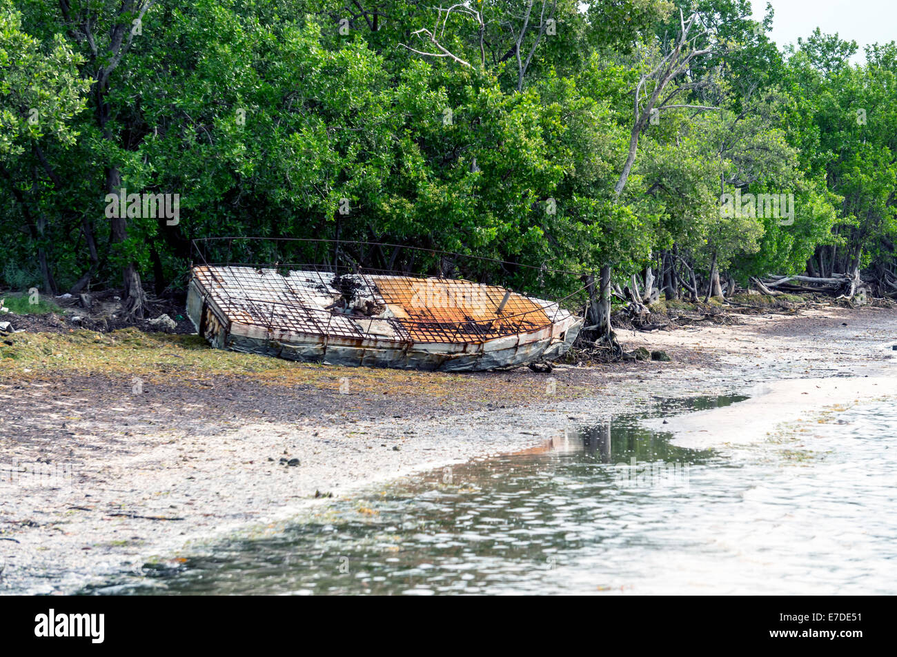 A beached shipwreck falling into ruin along a deserted shore of ...